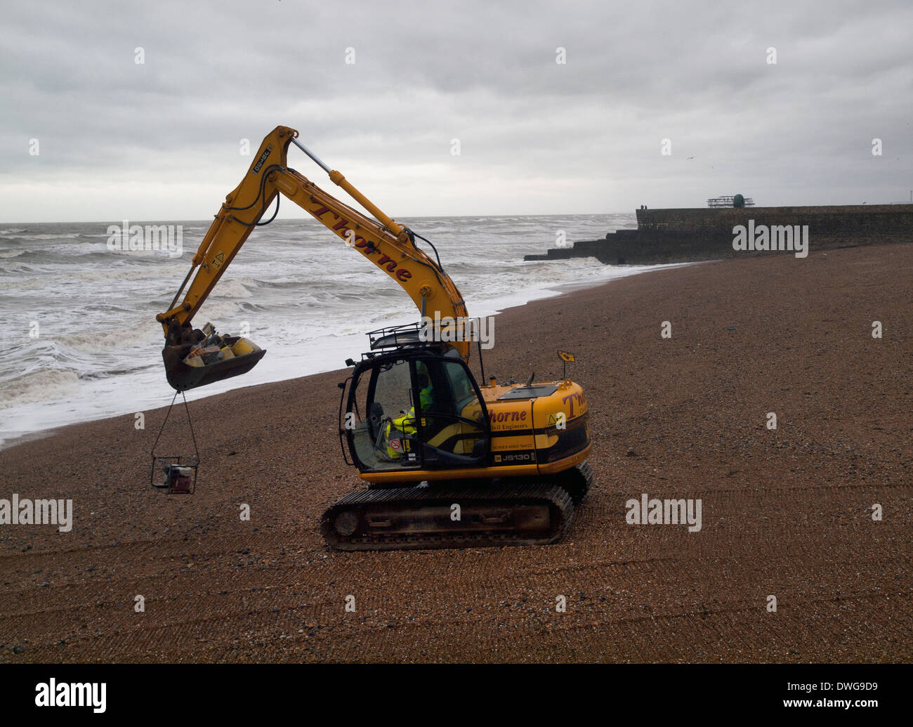 A JCB Digger on Brighton beach, being used for repairs to sea defences ...