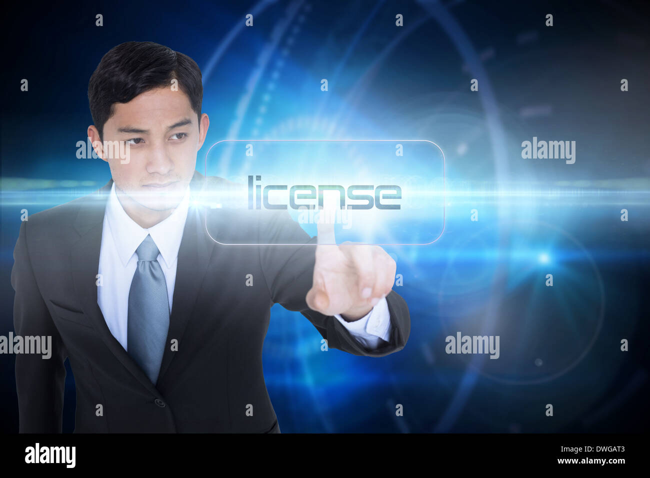 Businessman presenting the word license against glowing swirl on black ...