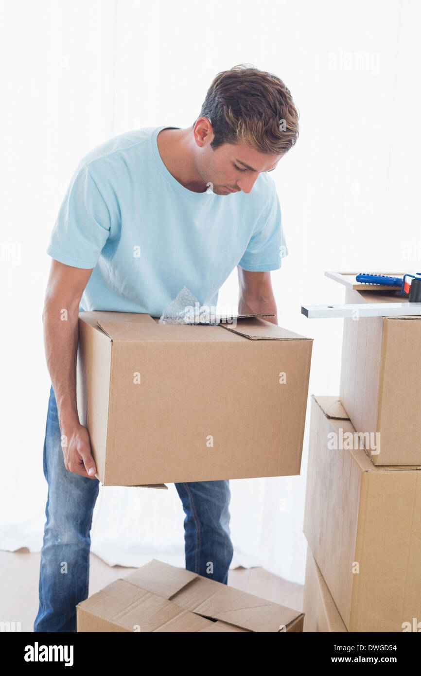 Man with cardboard boxes in new house Stock Photo - Alamy