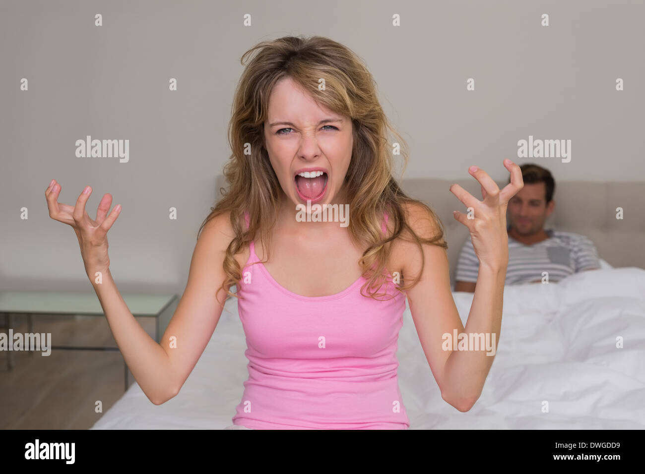Angry woman shouting with man in bed Stock Photo - Alamy