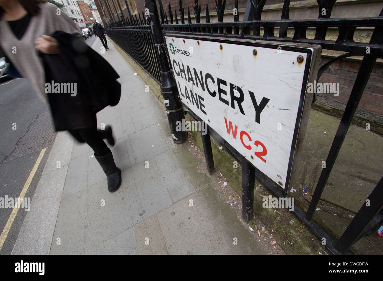 Commuter walks past street sign for Chancery Lane in London, United ...
