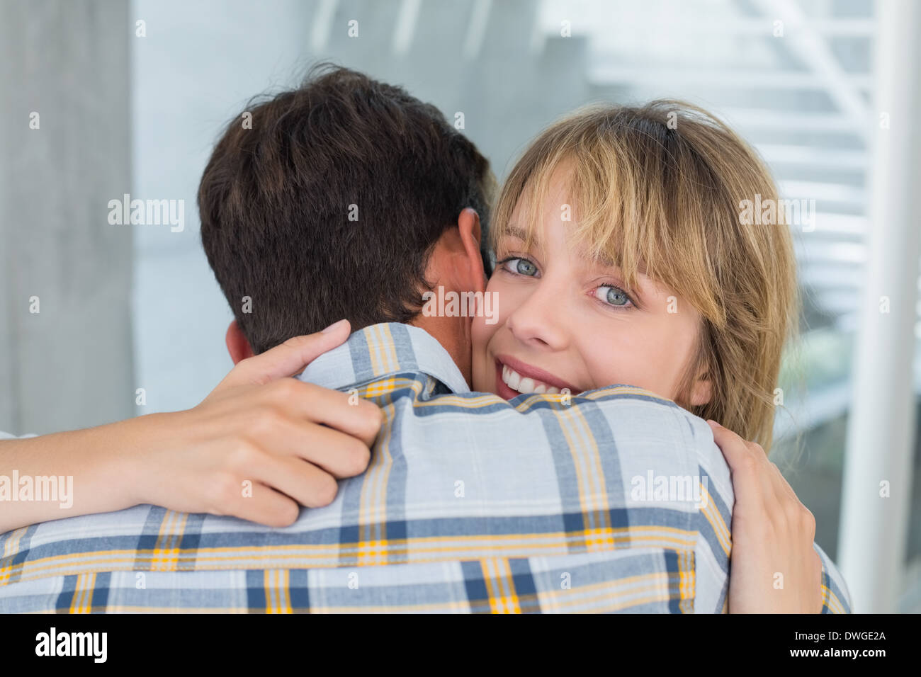 Loving young woman embracing man Stock Photo - Alamy