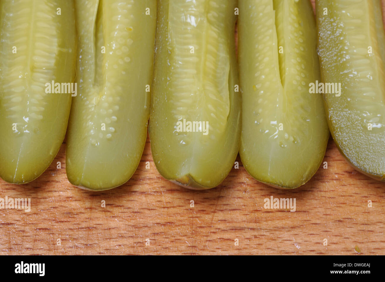 Quarters pickled cucumbers on a wooden worktop Stock Photo - Alamy