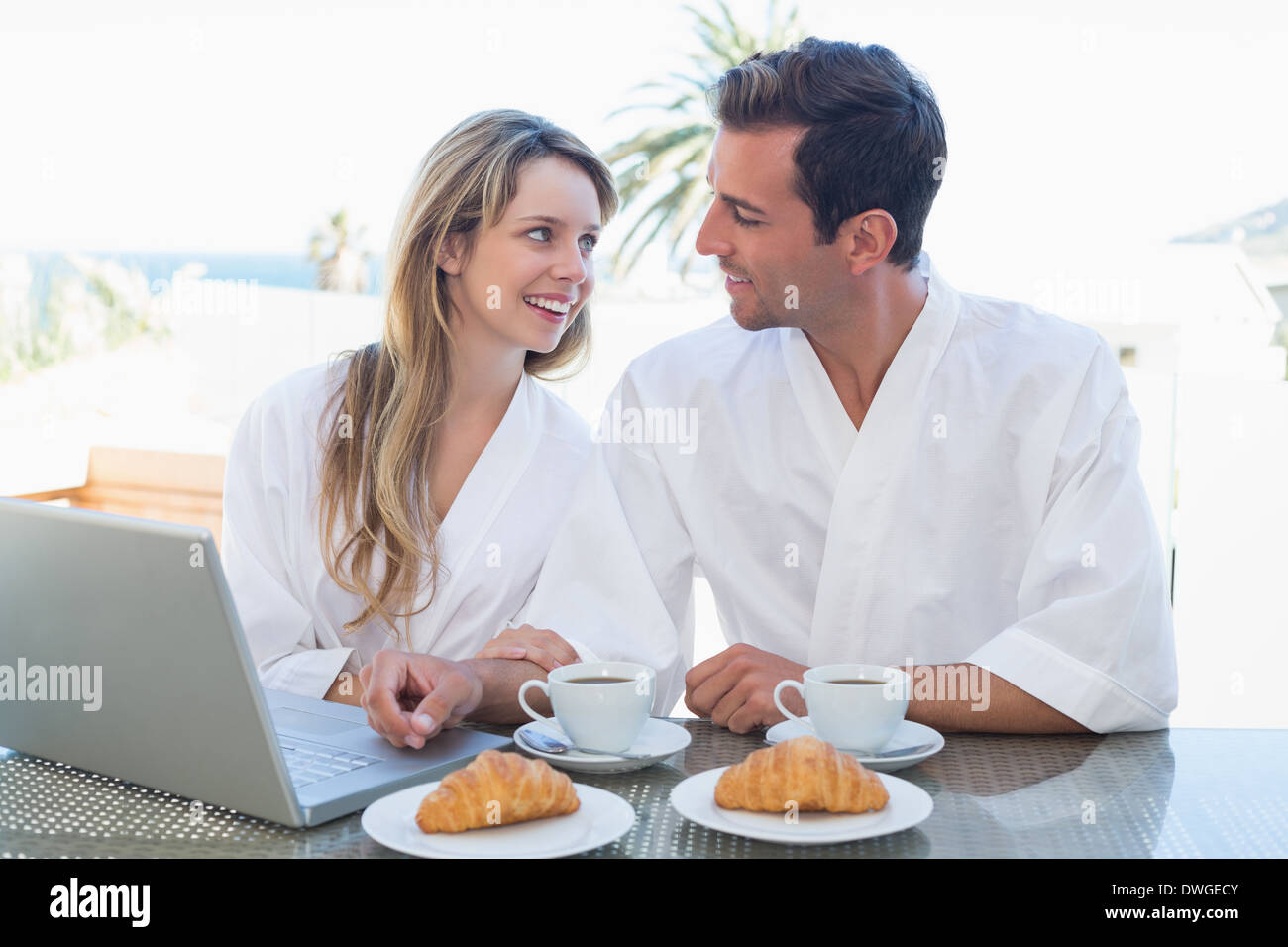 Bright couple using laptop on hi-res stock photography and images - Alamy
