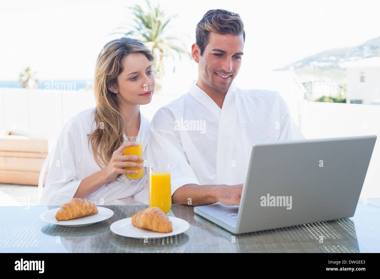 Bright couple using laptop on hi-res stock photography and images - Alamy