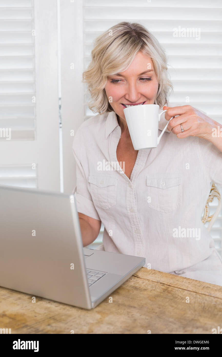 Mature woman drinking coffee using hi-res stock photography and images ...