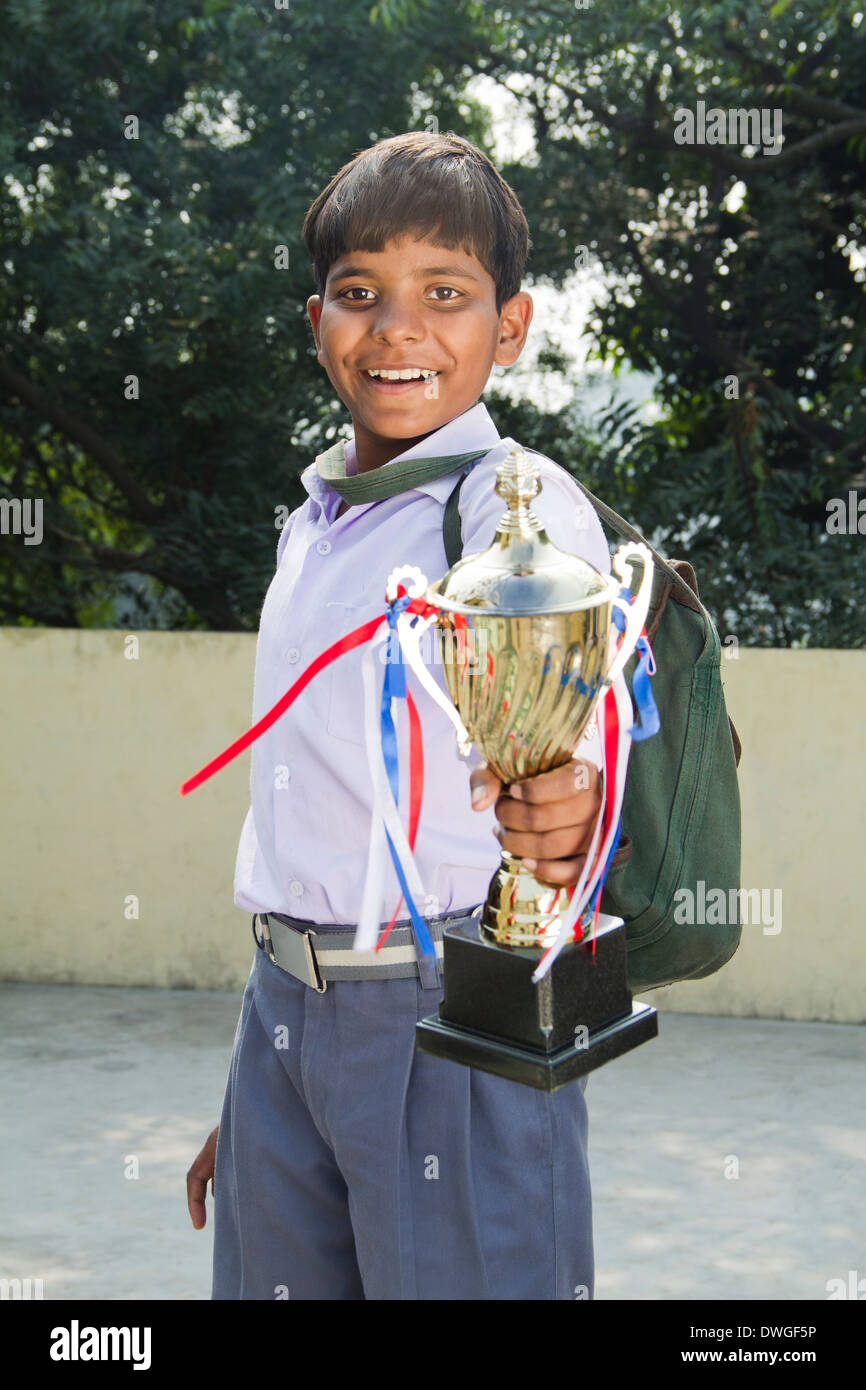 1 Indian kid student standing with trophy Stock Photo - Alamy