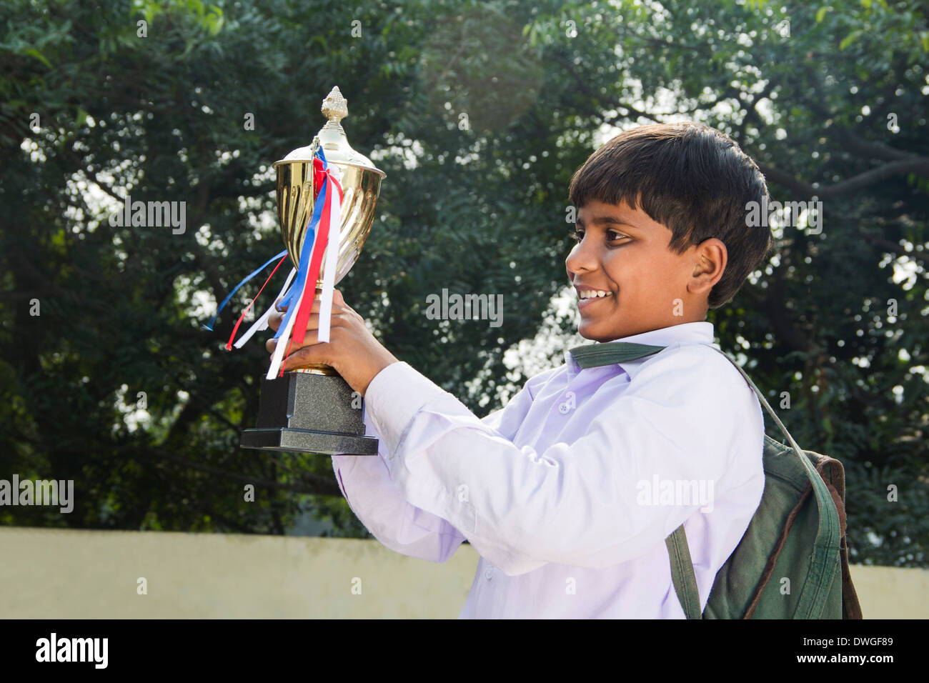 1 Indian kid student standing with trophy Stock Photo - Alamy