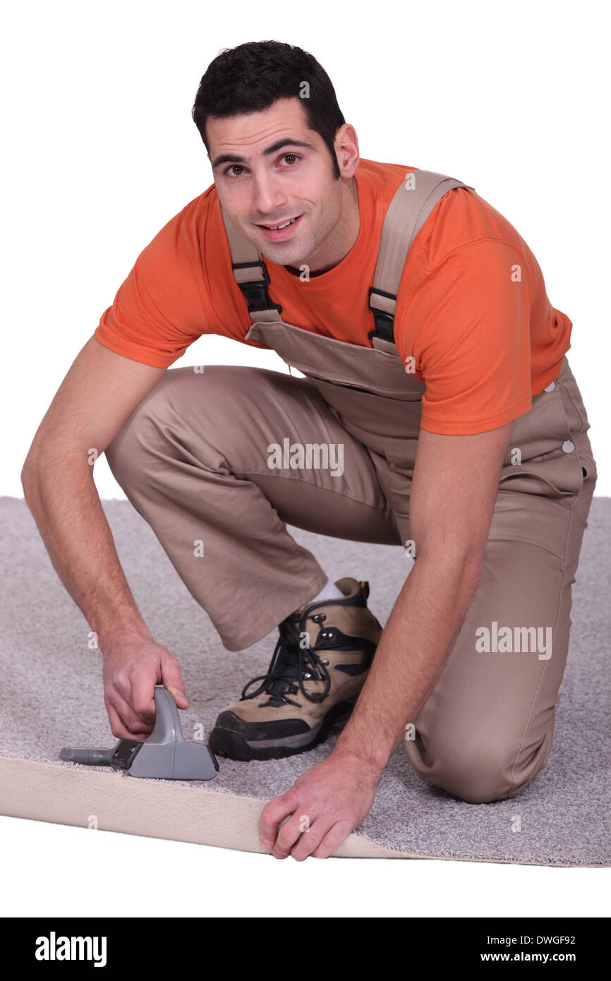Man placing carpet Stock Photo - Alamy