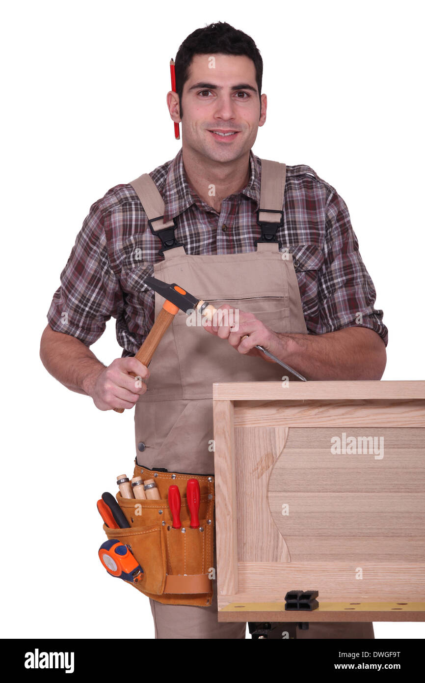 Carpenter with hammer and chisel Stock Photo - Alamy