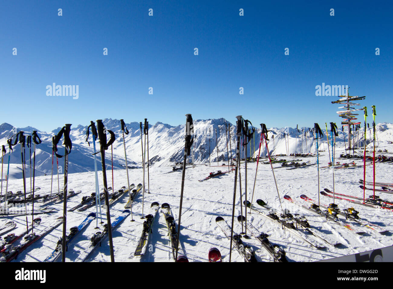 Scattered skis and ski poles at ski resort Stock Photo - Alamy