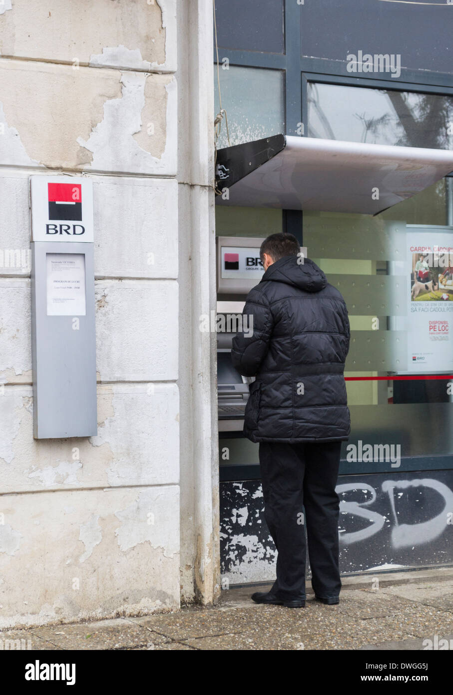 Man at BRD ATM in Bucharest, Romania Stock Photo - Alamy
