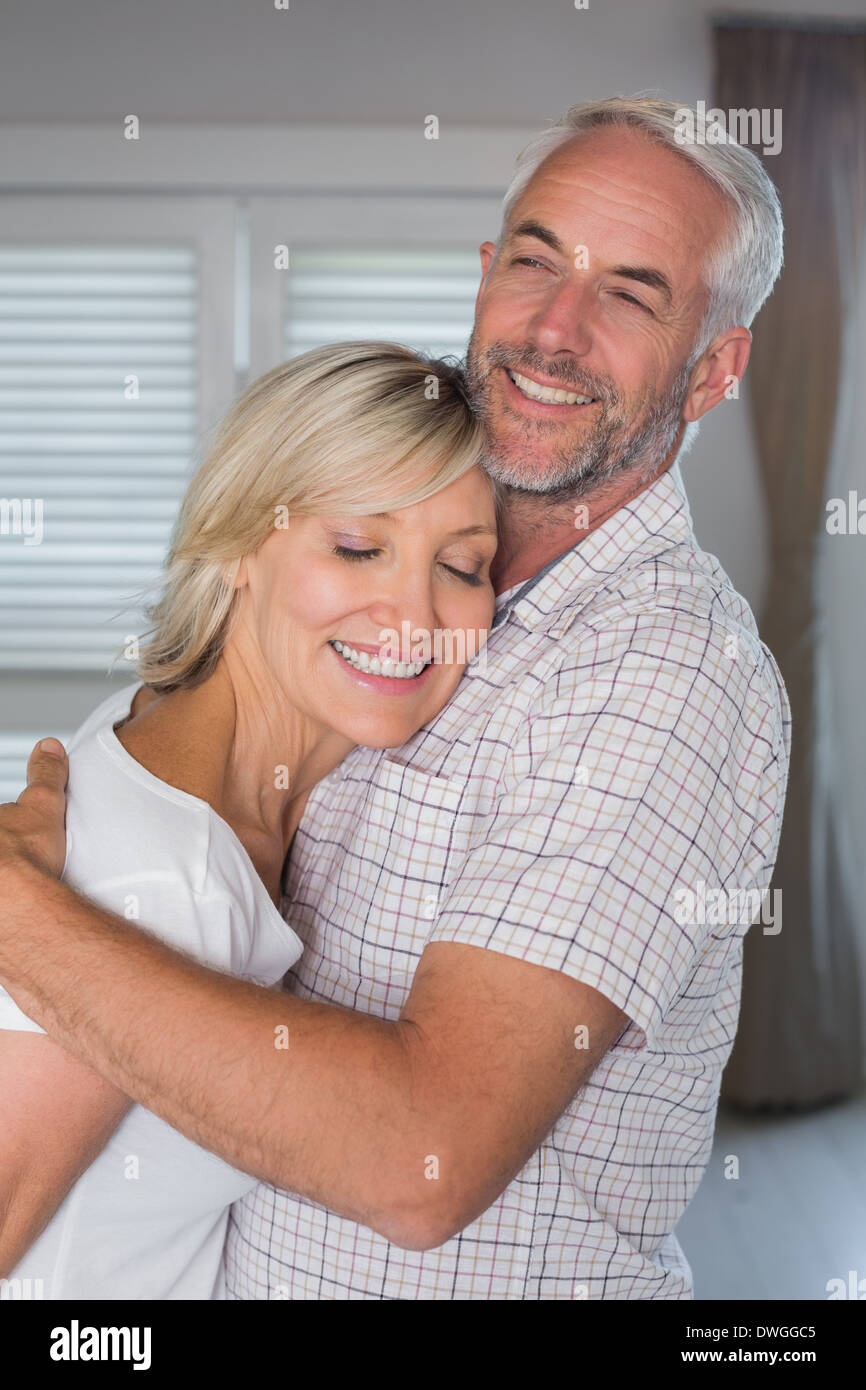 Mature couple embracing at home Stock Photo - Alamy