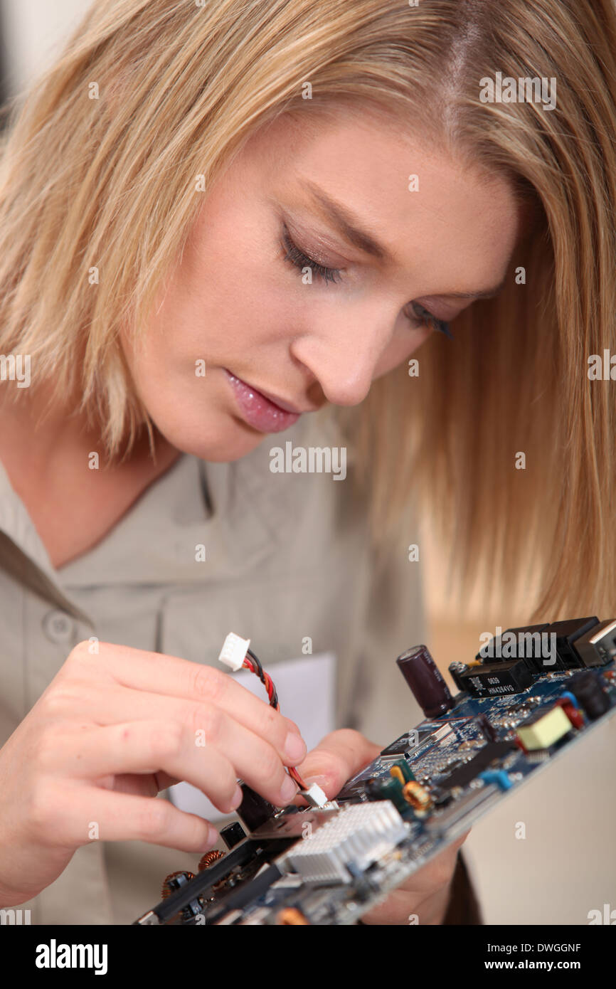 Woman with electronic component Stock Photo - Alamy