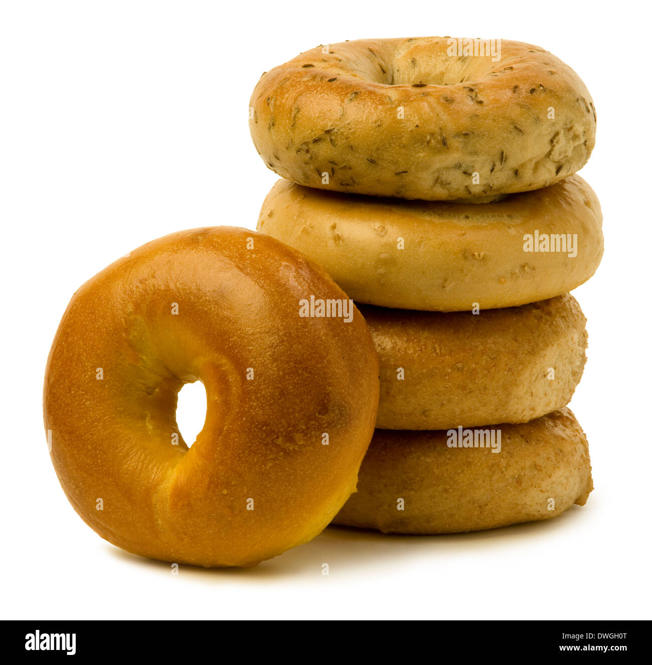 Stack of four bagels with one leaning on the side against white ...