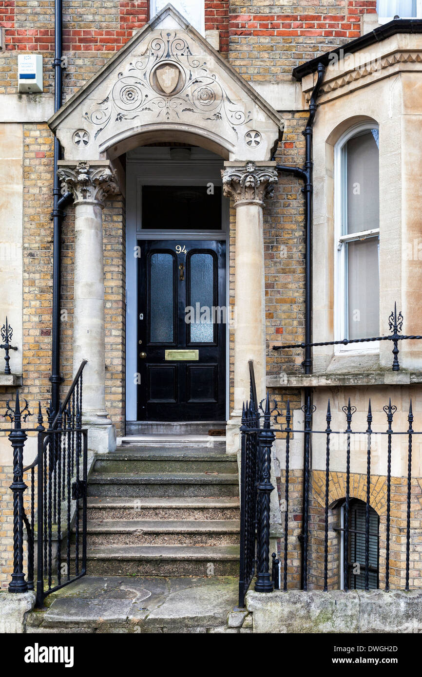 Decorative stone arch and columns of house entrance in Lambeth Road ...