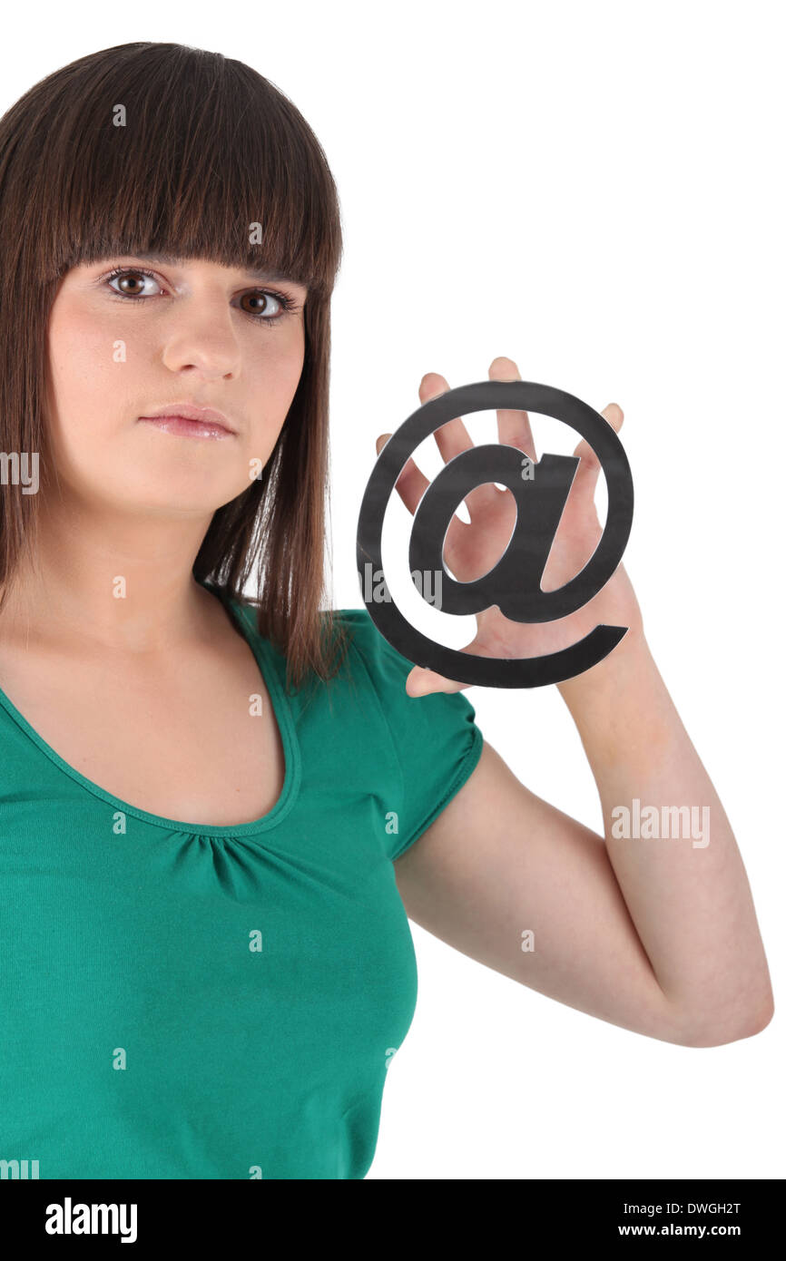Teenager holding an at sign Stock Photo - Alamy