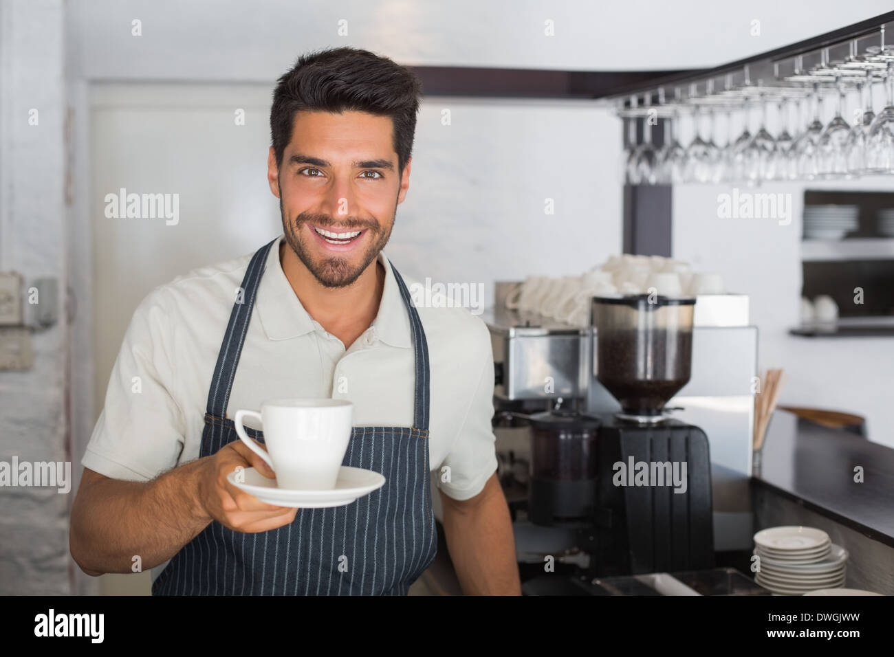 Smiling male barista holding cup of coffee at caf├⌐ Stock Photo - Alamy