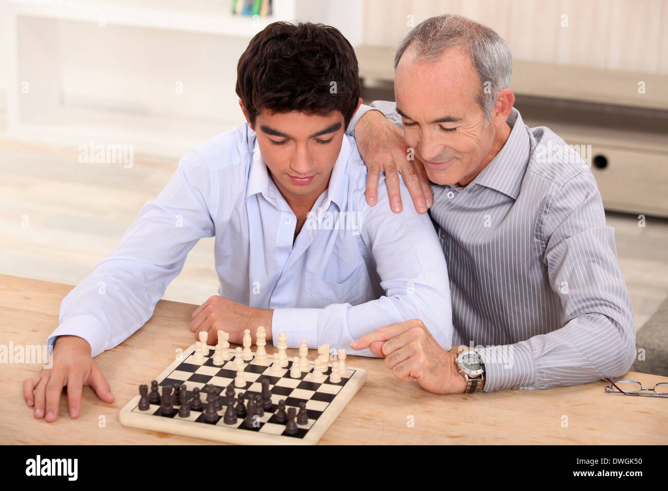 Father and son playing chess Stock Photo - Alamy