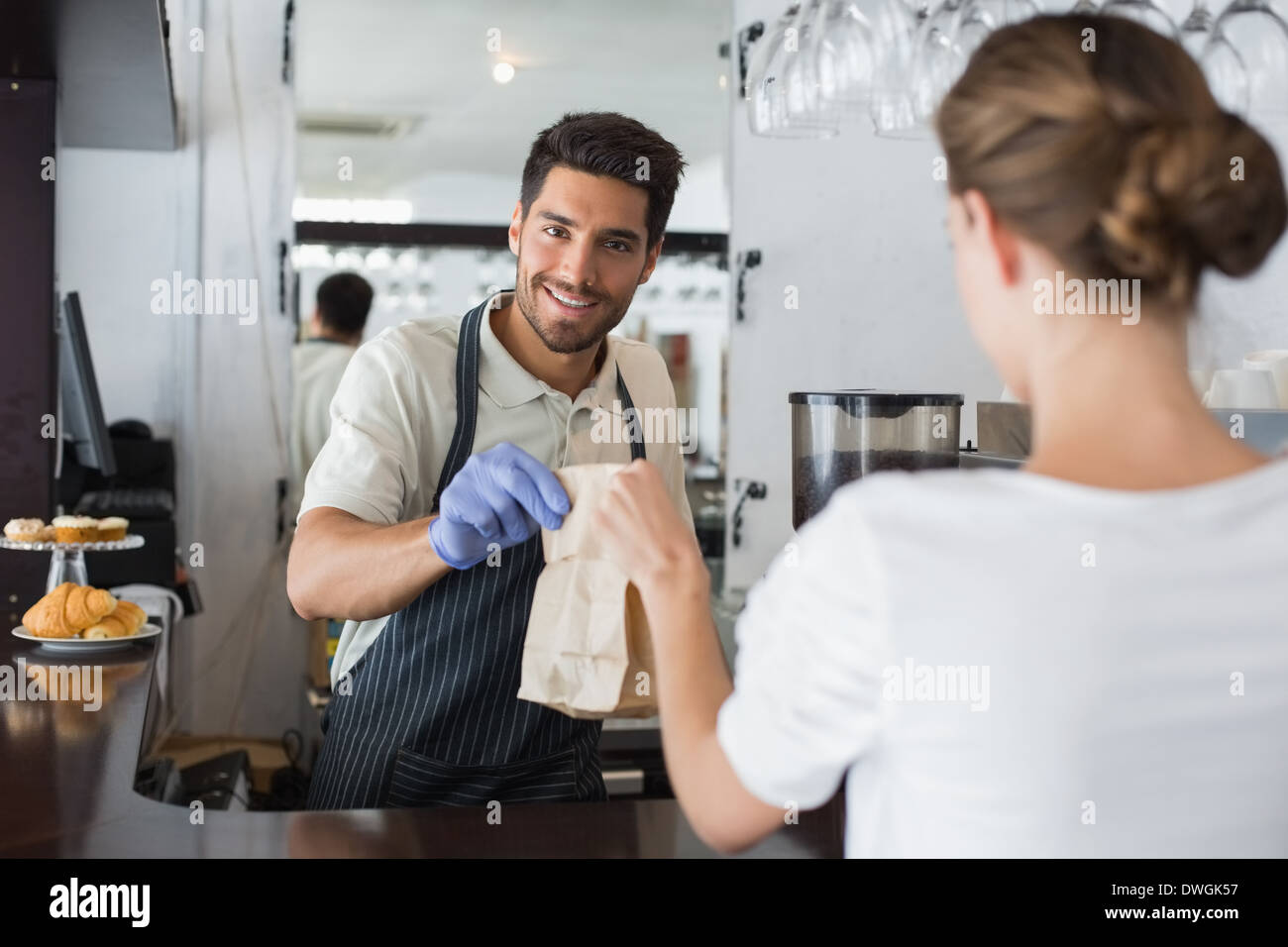 Waiter giving packed food to a woman at coffee shop Stock Photo - Alamy