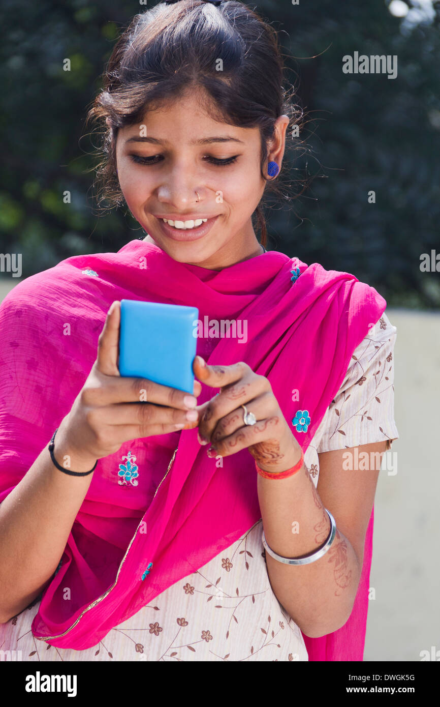 1 Indian Rural girl standing mobile phone Stock Photo - Alamy