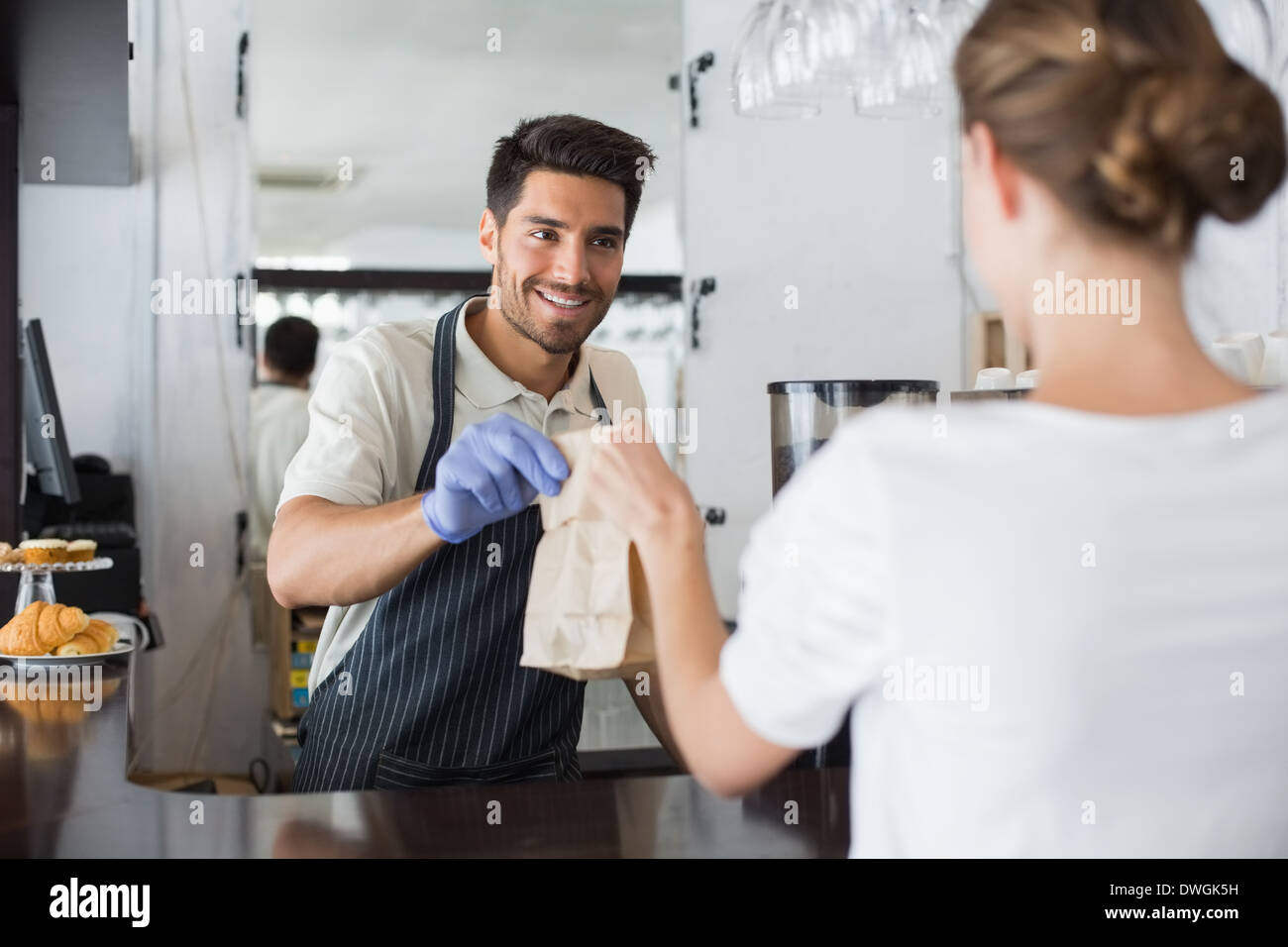 Waiter giving packed food to a woman at coffee shop Stock Photo - Alamy