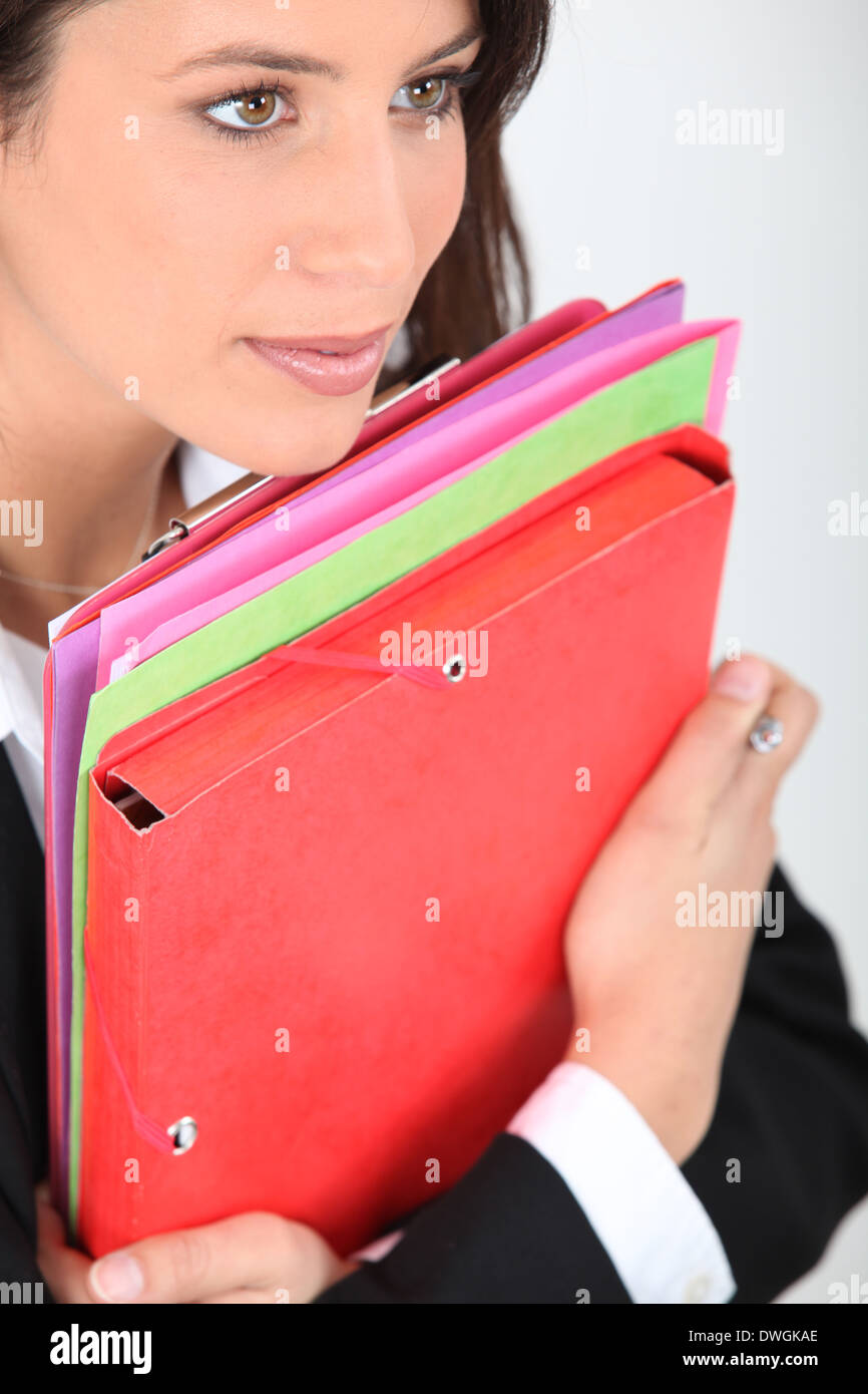 young woman dressed in suit holding file folders Stock Photo - Alamy