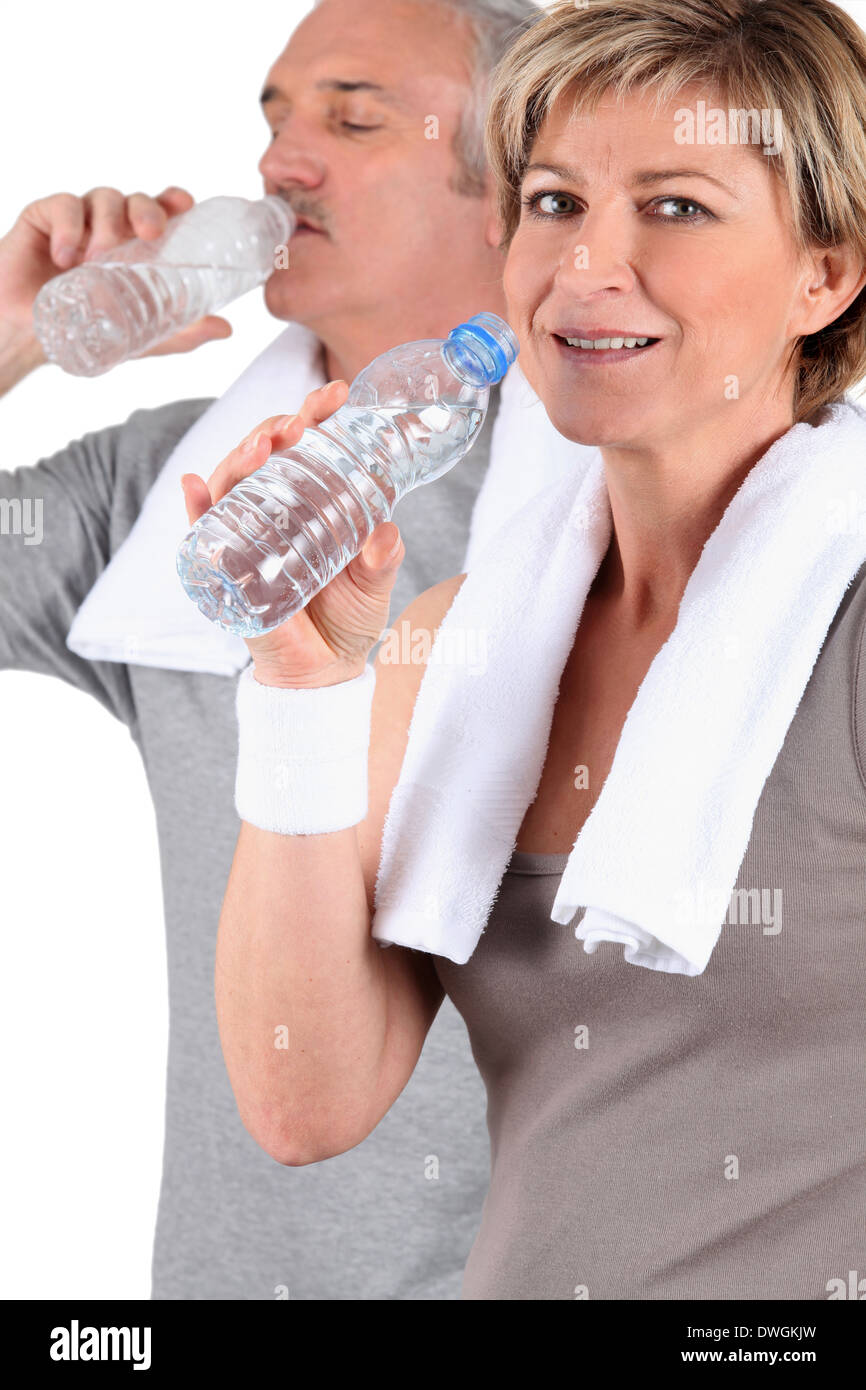 couple senior drinking water after training Stock Photo - Alamy