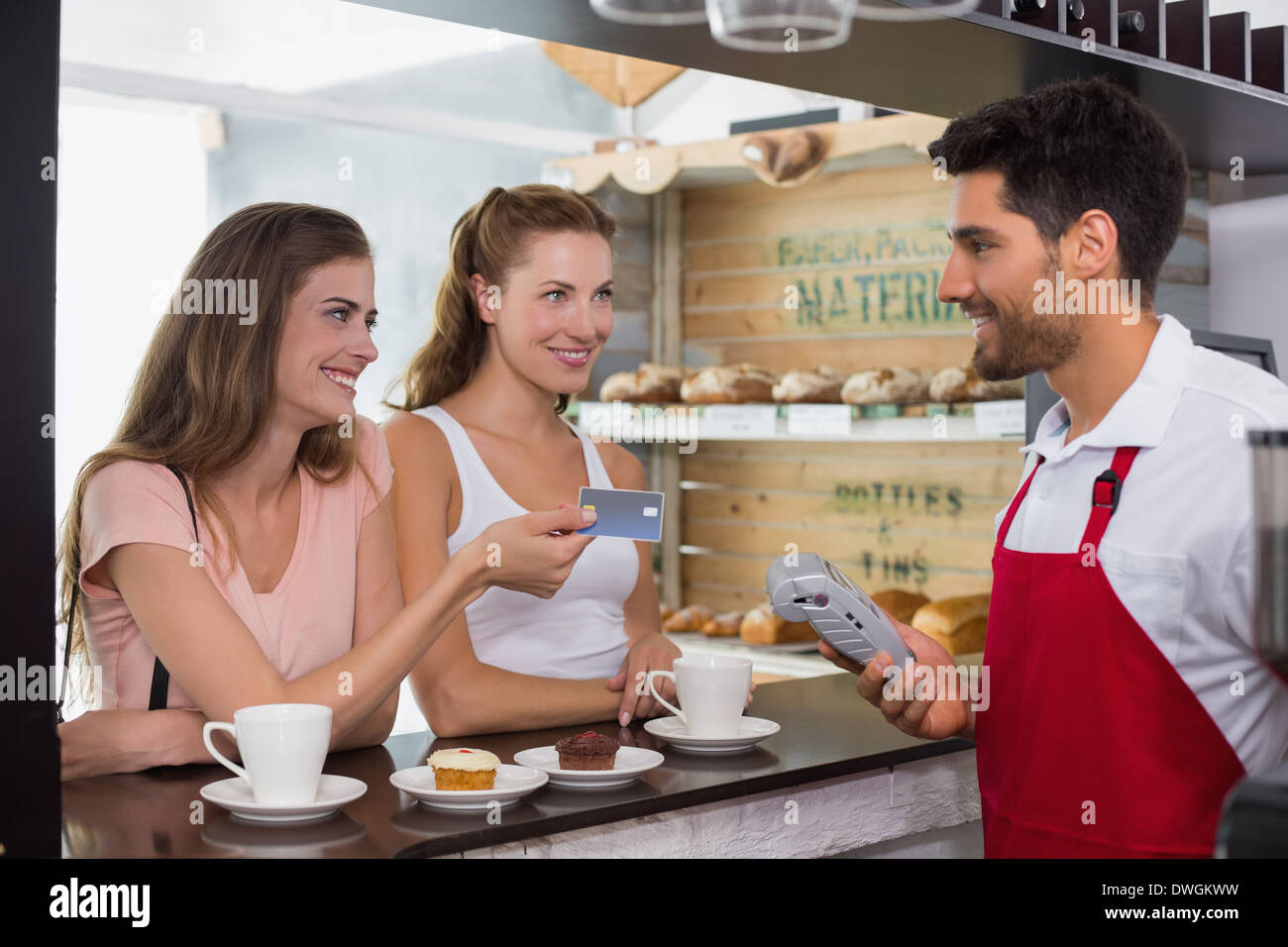 Female barista holding out coffee hi-res stock photography and images ...