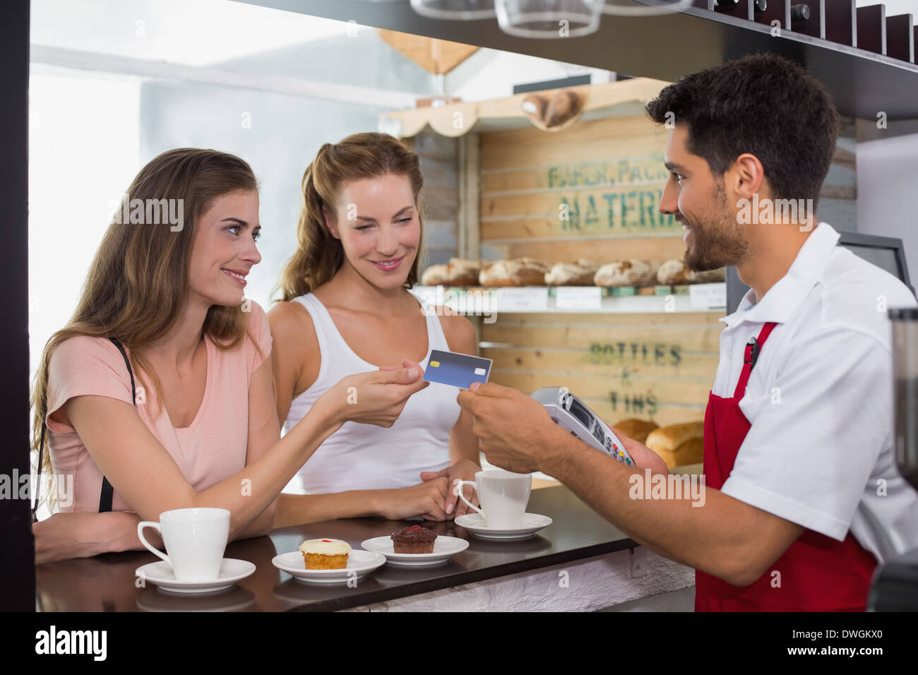 Female barista holding out coffee hi-res stock photography and images ...