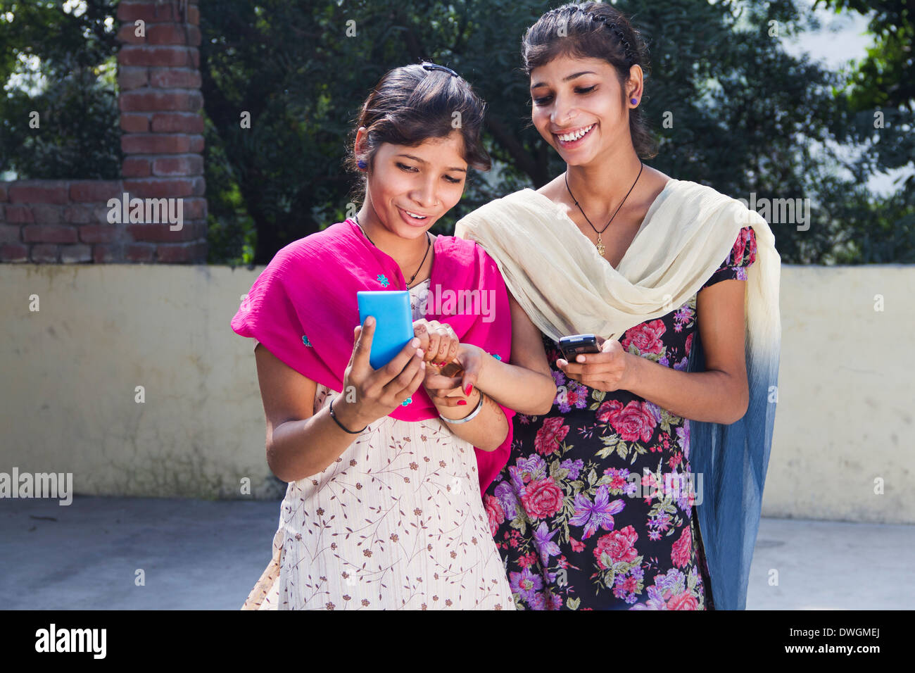Two girls standing talking hi-res stock photography and images - Alamy