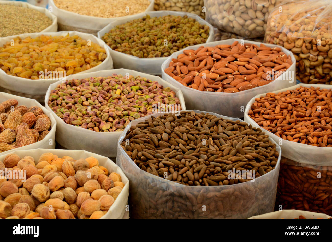 Variety of raw nuts, pistachios, figs, almonds, pine nuts, raisins, for ...