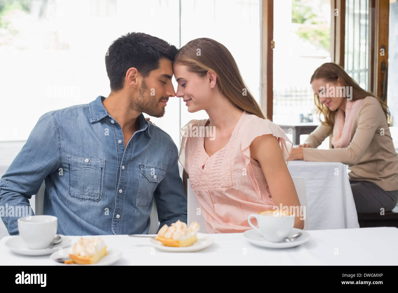 Romantic couple having coffee at coffee shop Stock Photo - Alamy