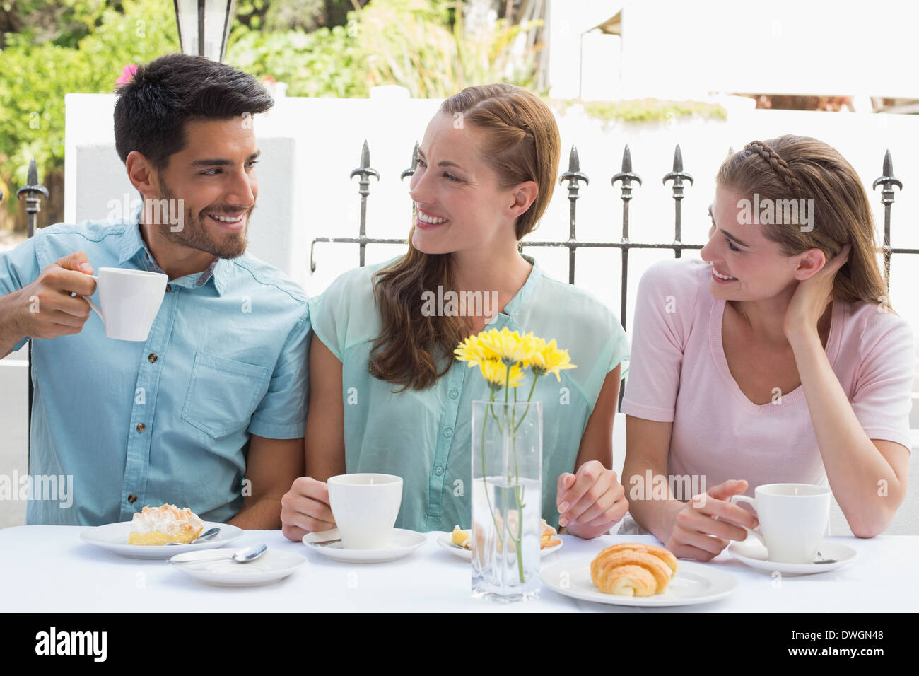 Three happy friends having coffee in caf├⌐ Stock Photo - Alamy
