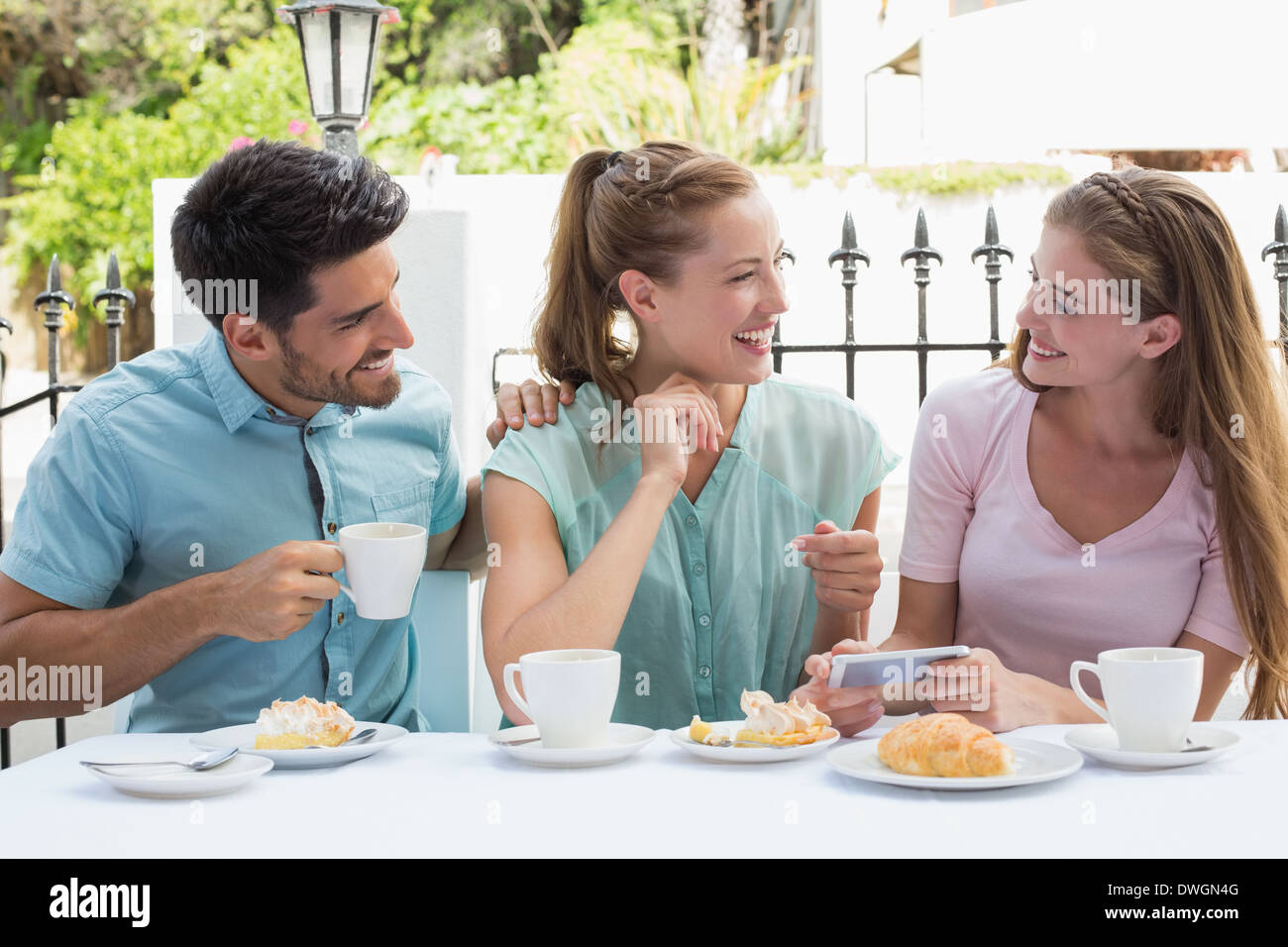 Happy friends reading text message in caf├⌐ Stock Photo - Alamy