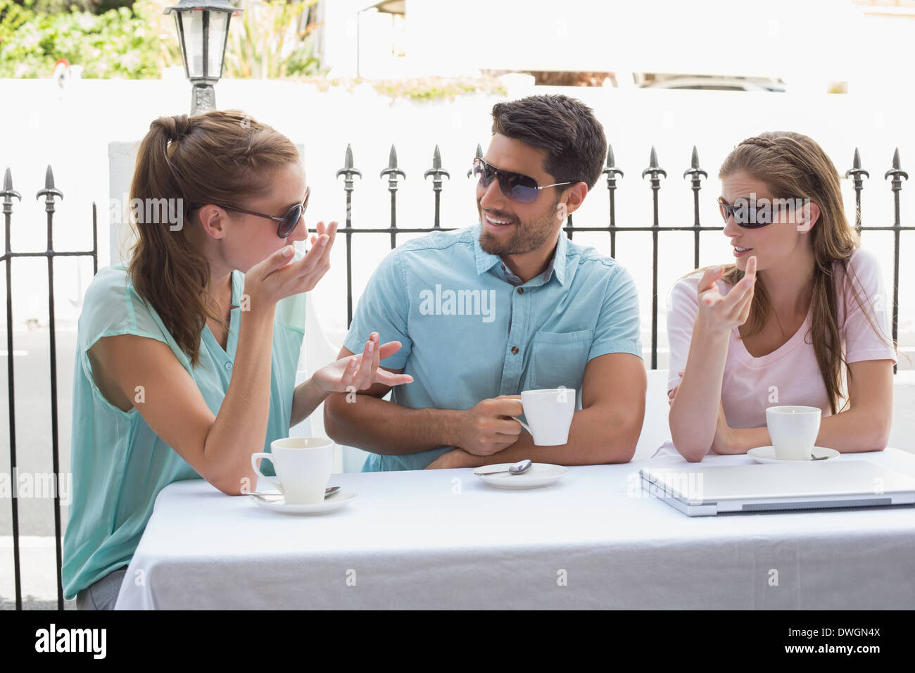 Three happy friends having coffee in caf├⌐ Stock Photo - Alamy