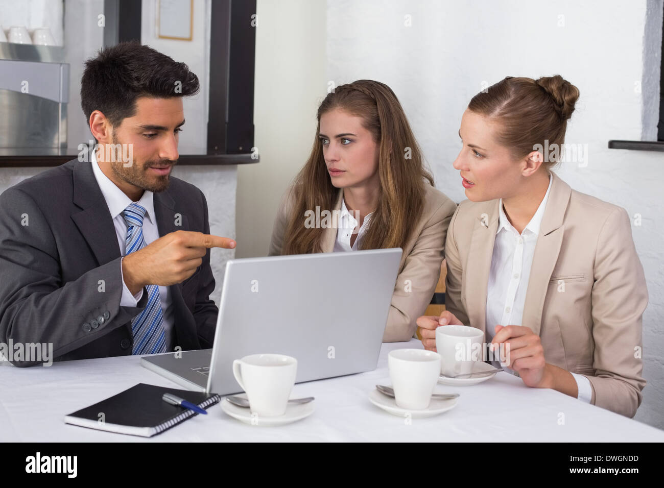 Business people using laptop together at office desk Stock Photo - Alamy