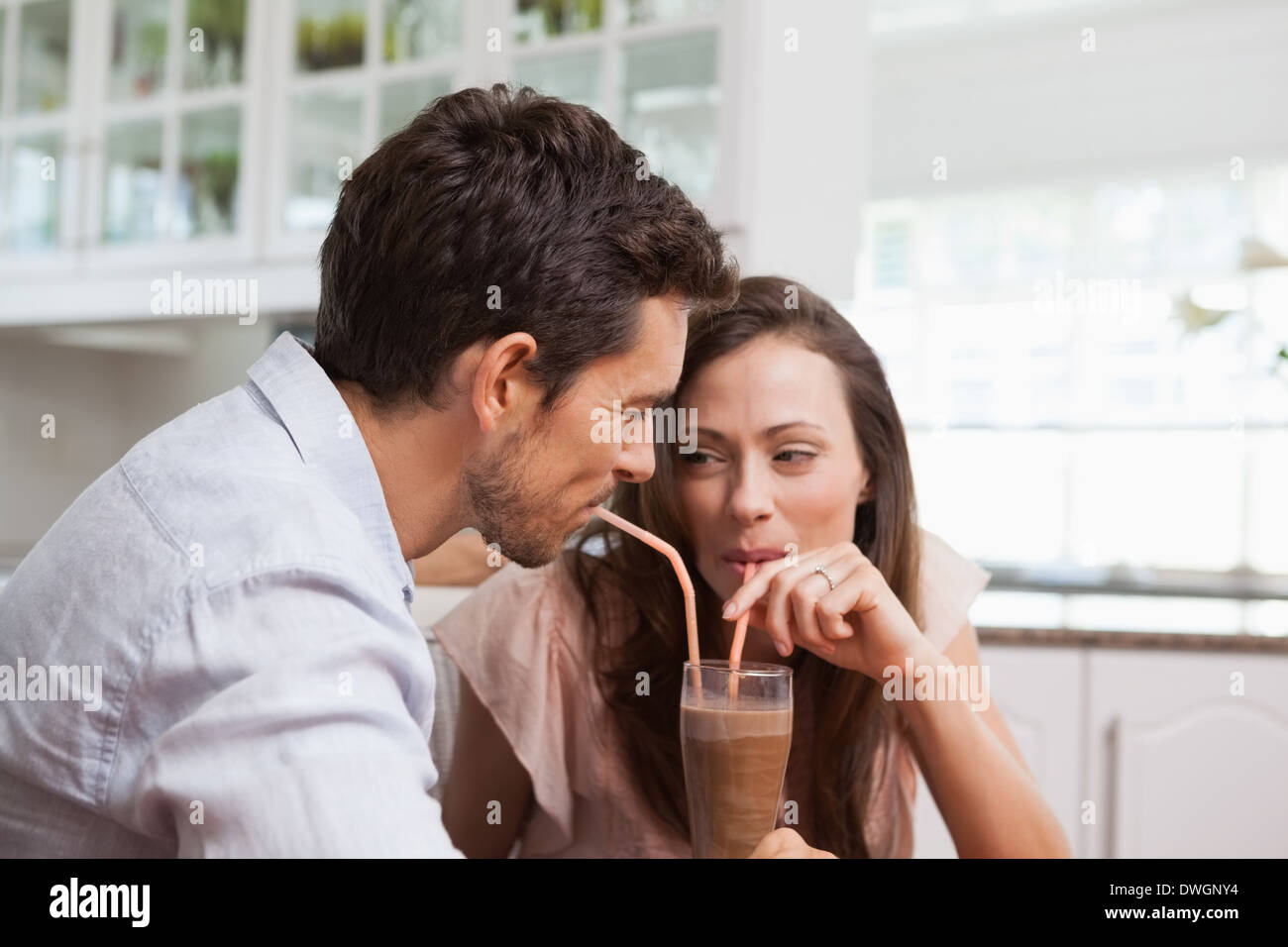 Romantic couple sharing glass hi-res stock photography and images - Alamy