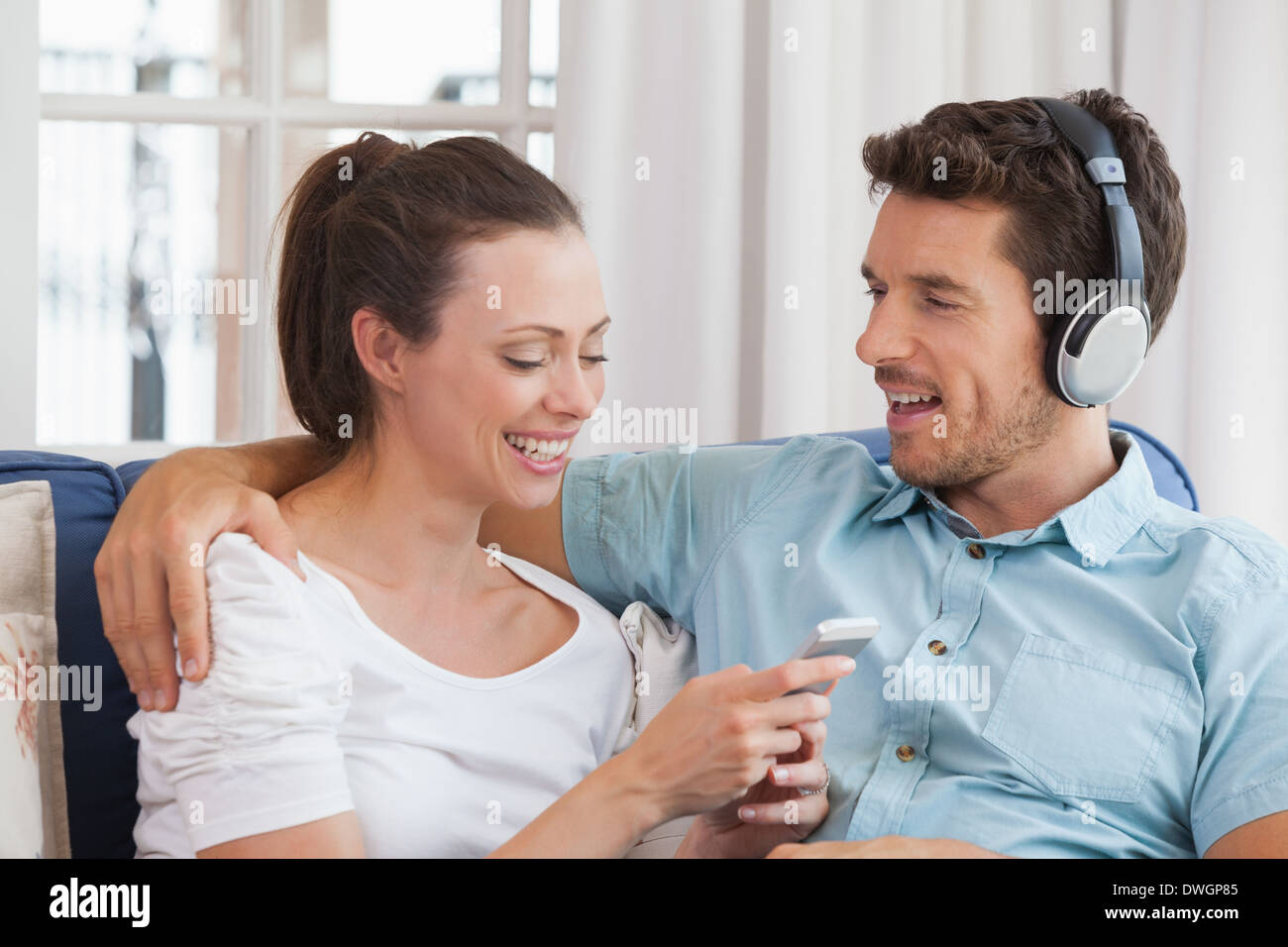 Woman on couch listening texting hi-res stock photography and images ...