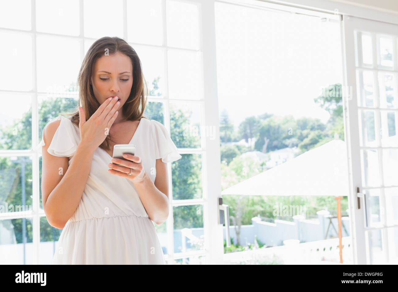 Shocked woman reading text message Stock Photo - Alamy