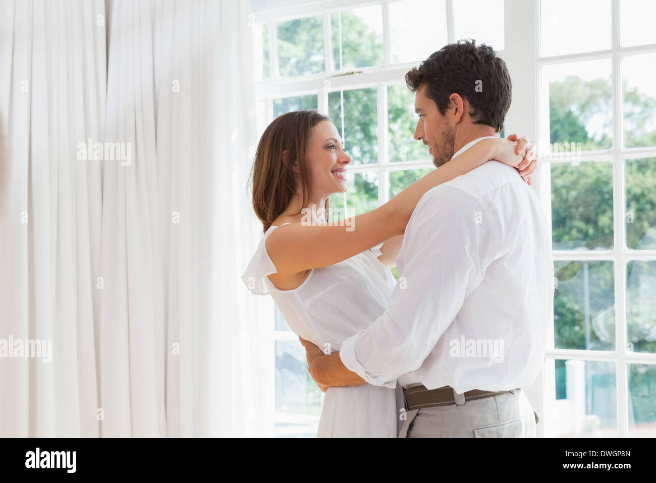 Side view attractive couple hugging hi-res stock photography and images ...