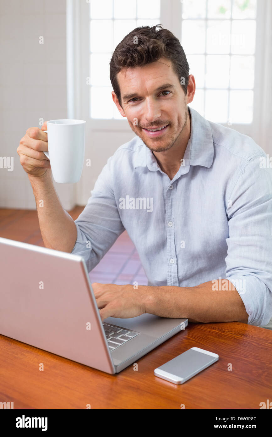 Portrait of a smiling man with coffee cup Stock Photo - Alamy
