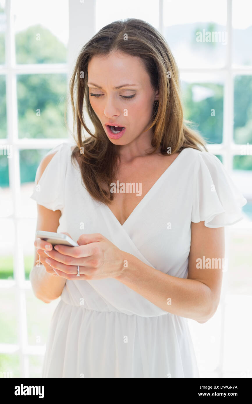 Shocked woman reading text message Stock Photo - Alamy