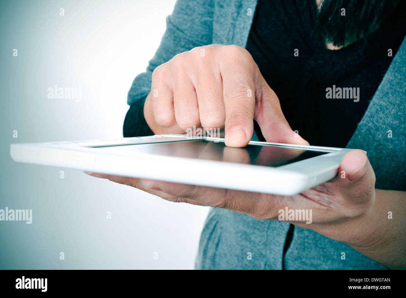 a woman in casual wear using a tablet computer Stock Photo - Alamy