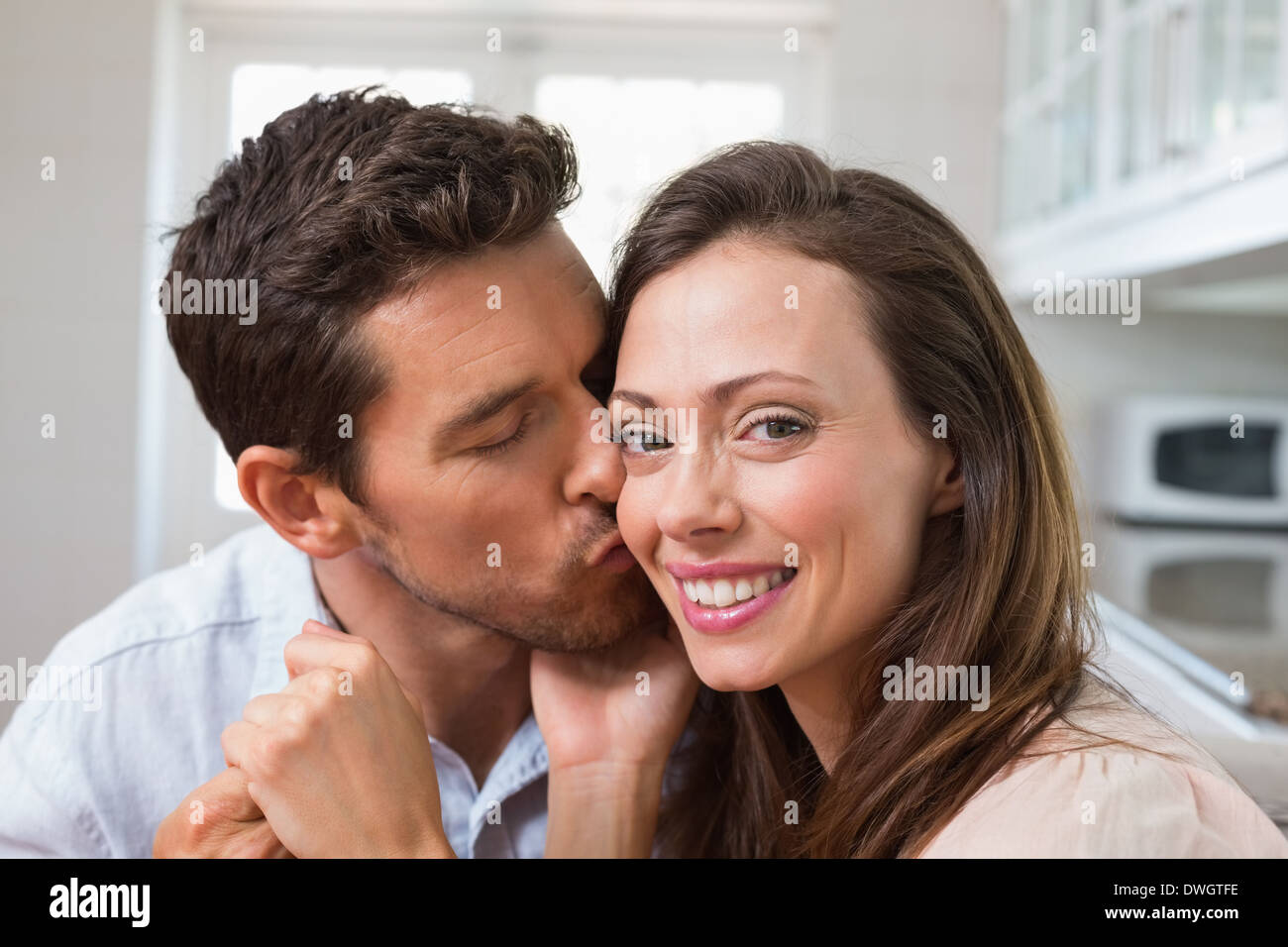 Close up of man kissing woman on cheek hi-res stock photography and images - Alamy