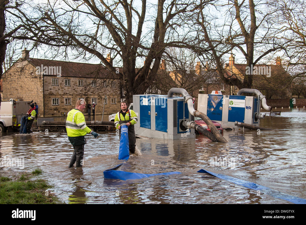 Environment Agency workers using high pressure pumps to drain flooding ...