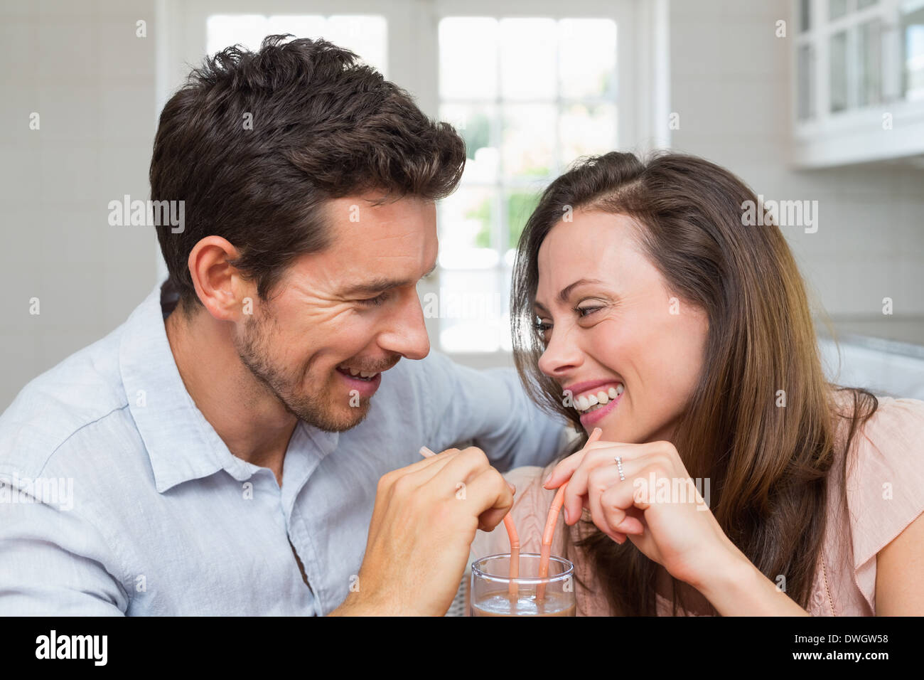 Couple sharing a drink hi-res stock photography and images - Alamy