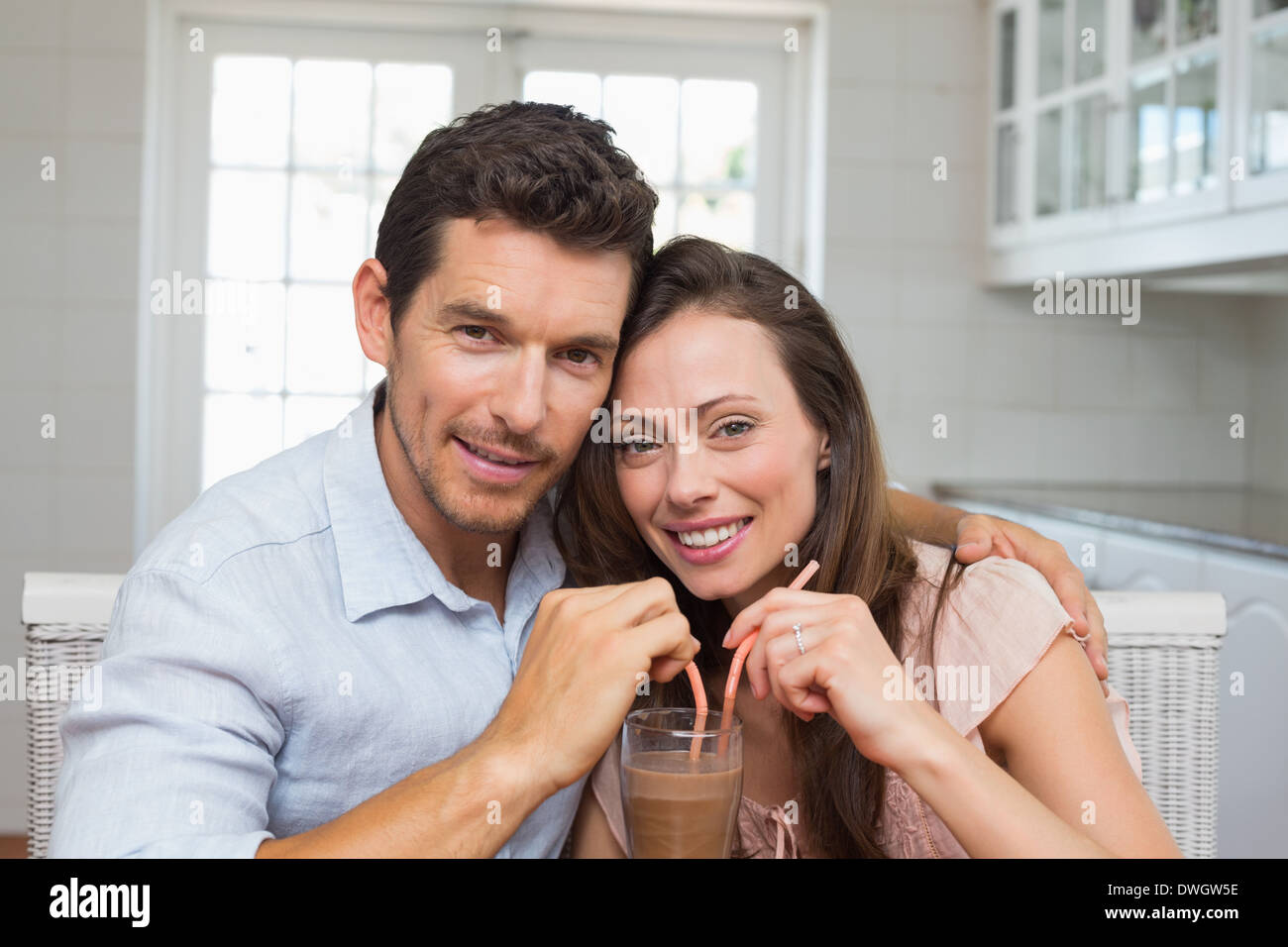 Romantic couple sharing glass hi-res stock photography and images - Alamy