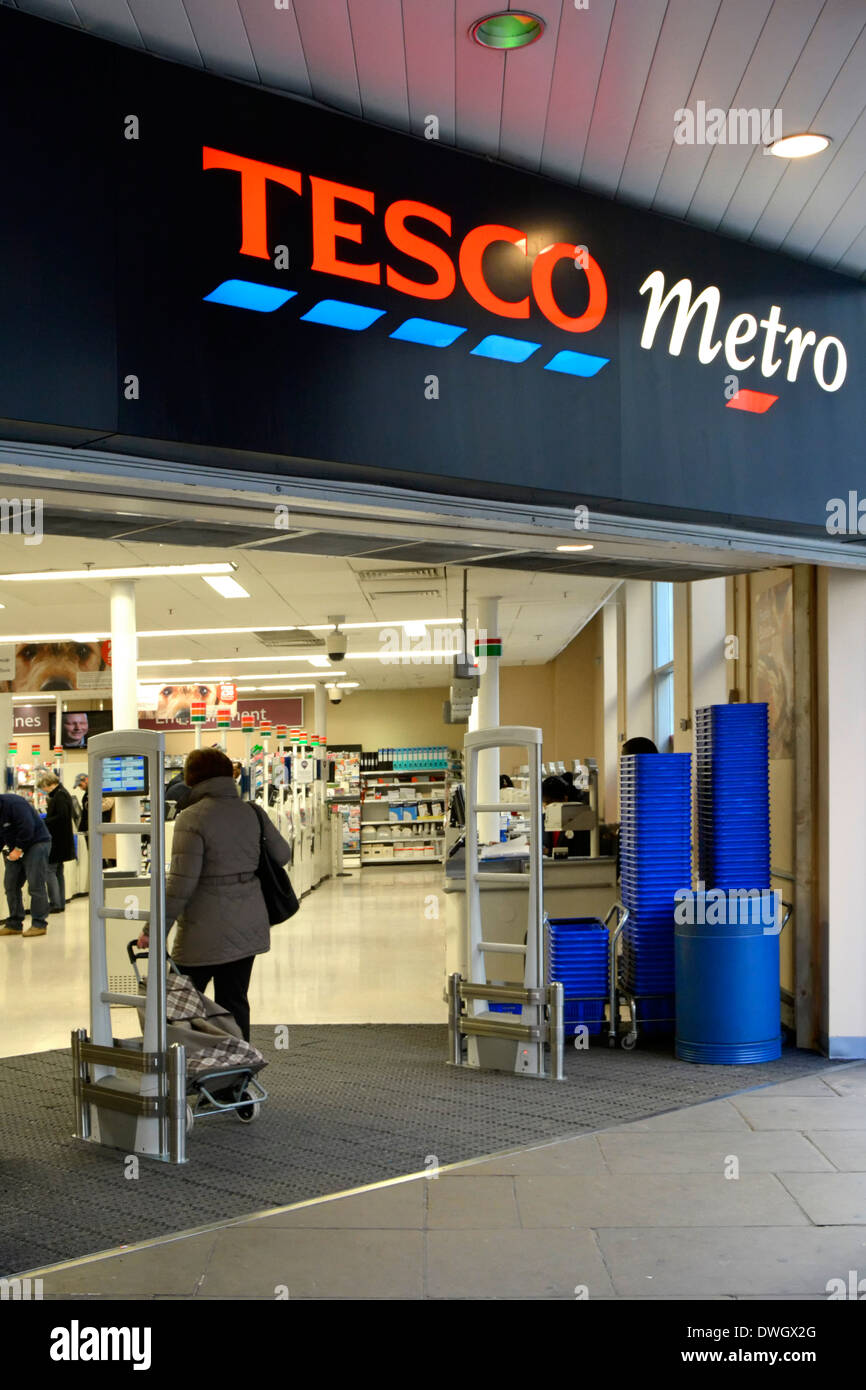 Tesco Metro shop front sign and entrance exit with security scanners ...