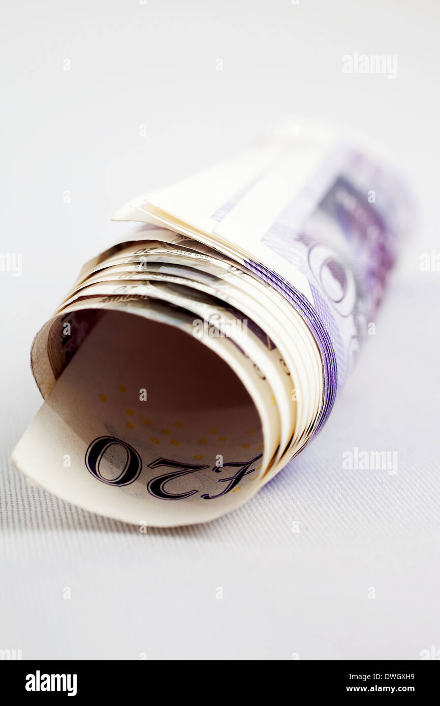 A roll of bank notes on white background Stock Photo - Alamy